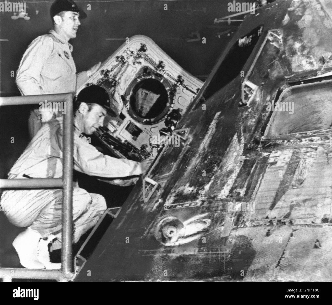 Safely aboard the prime recovery ship, USS Iwo Jima, astronauts James ...