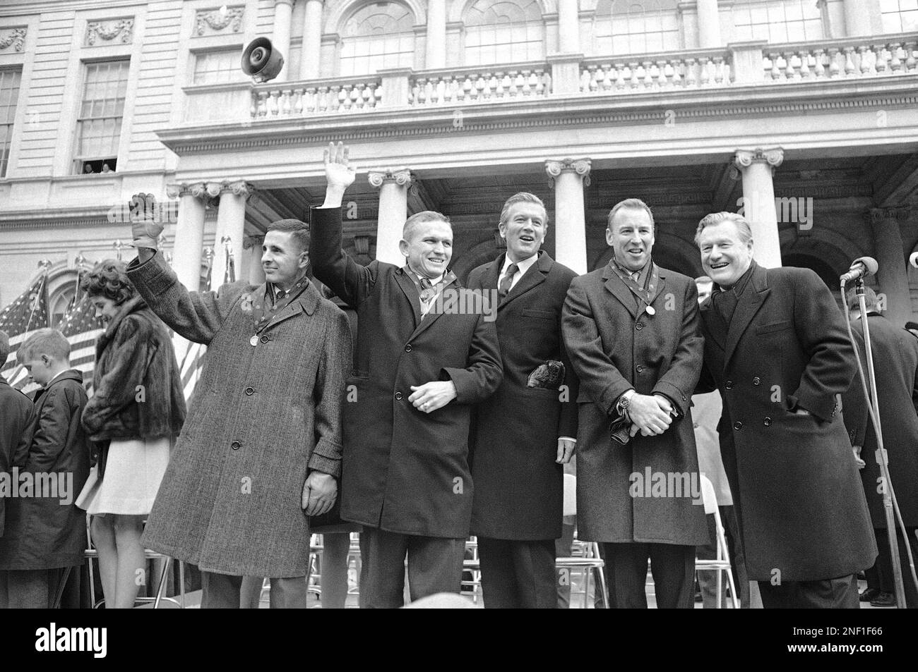 Wearing medals of honor presented by the city, the Apollo 8 astronauts ...