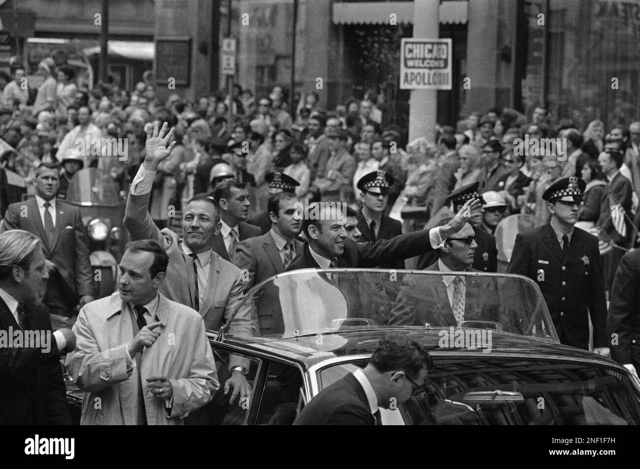 Apollo 13 astronauts John Swigert Jr., with his arms upraise and James ...