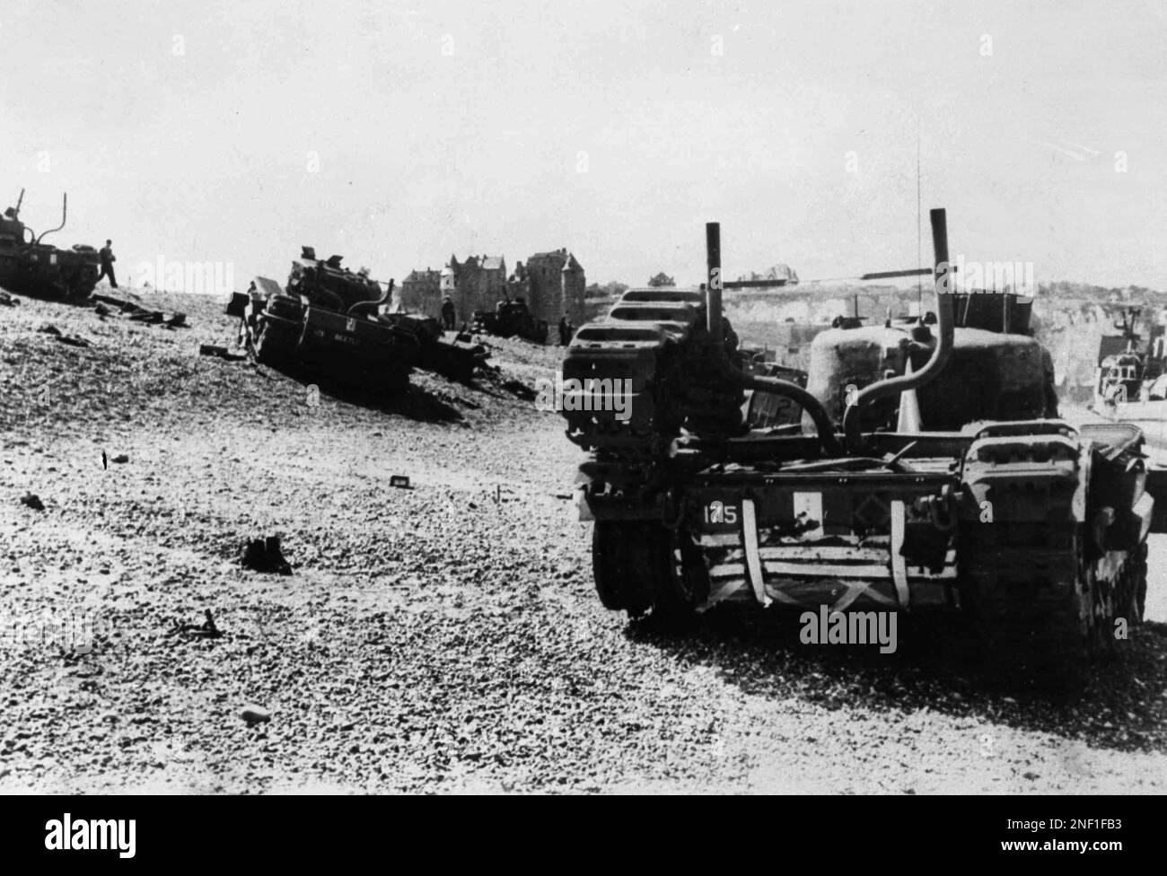 British and Canadian tanks stand on the shingle on the beach at Dieppe ...