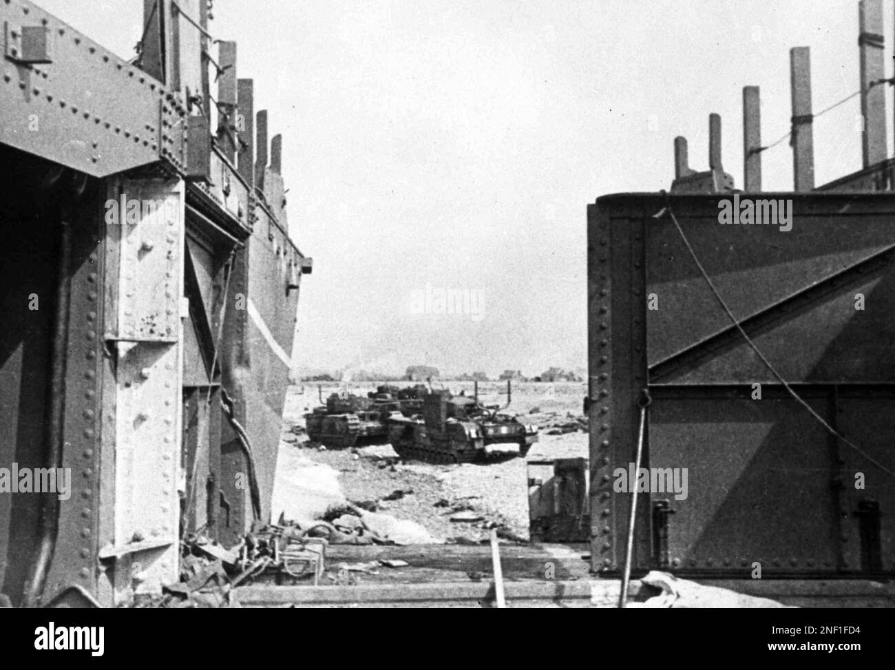 Seen through the doors of a landing craft, British and Canadian tanks ...