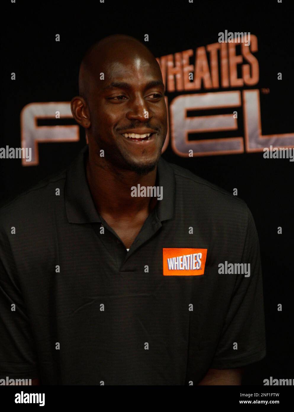 Basketball player Kevin Garnett smiles as he sits down to breakfast to ...