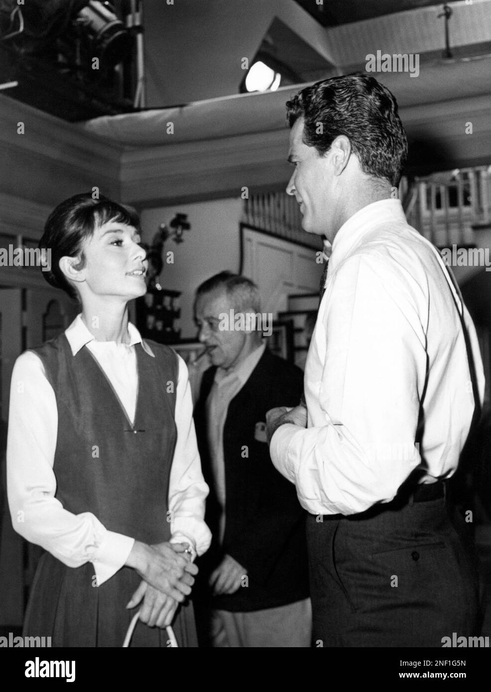 Actress Audrey Hepburn, left, and actor James Garner are shown waiting ...