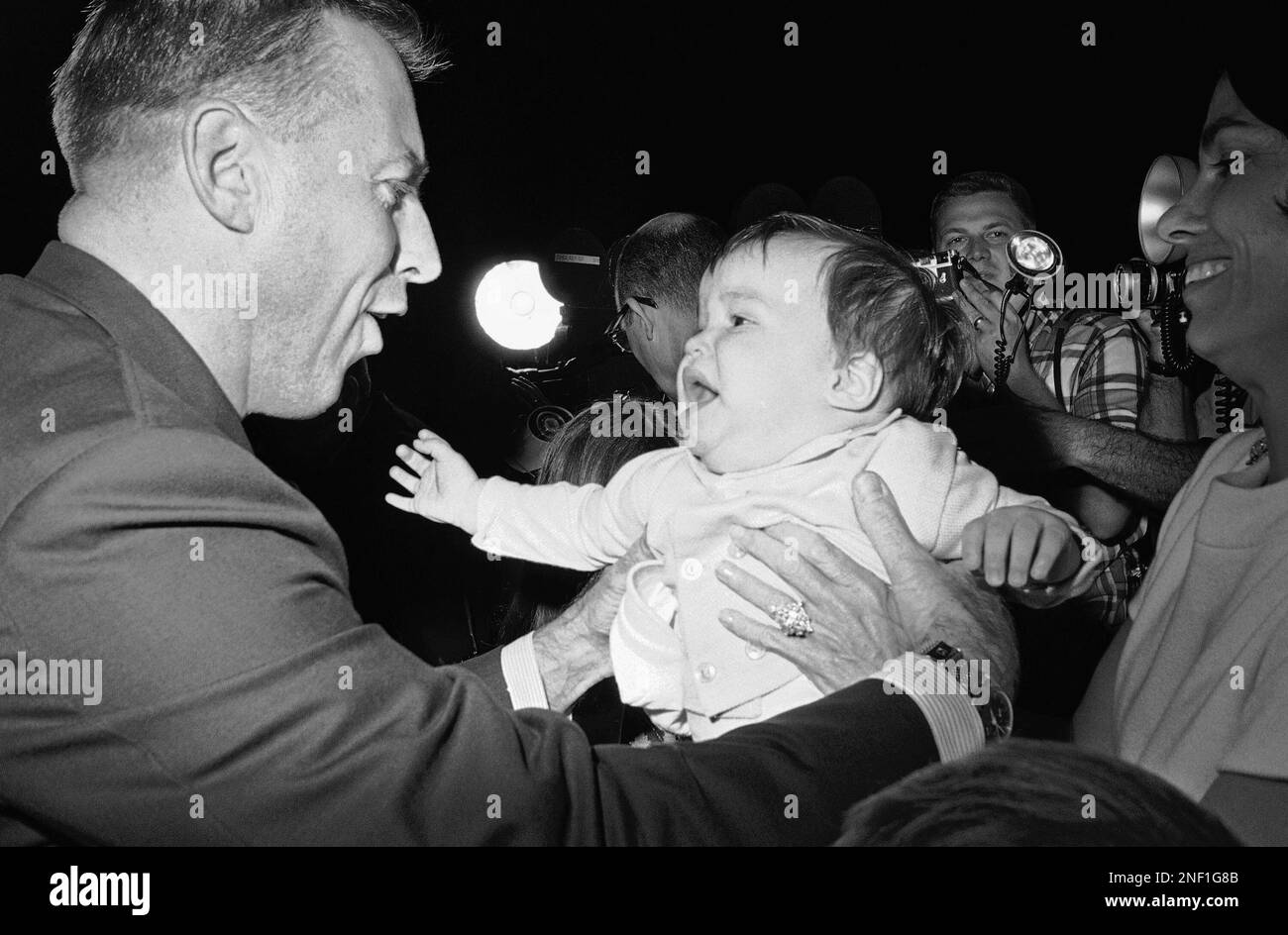 Command Pilot James Lovell, of Gemini 12, left, is greeted by the ...