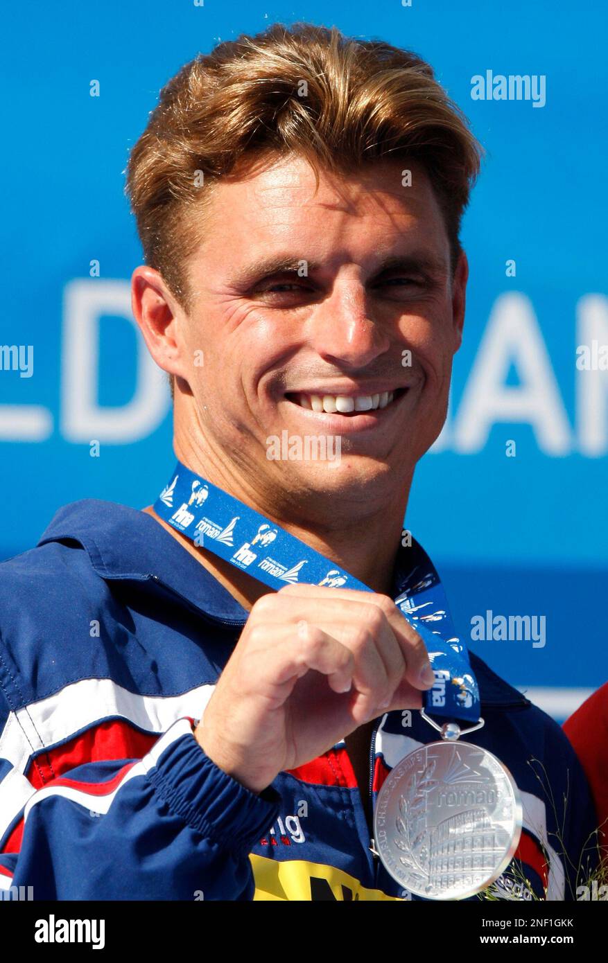Troy Dumais of the United States shows the silver medal of the men's 3 ...