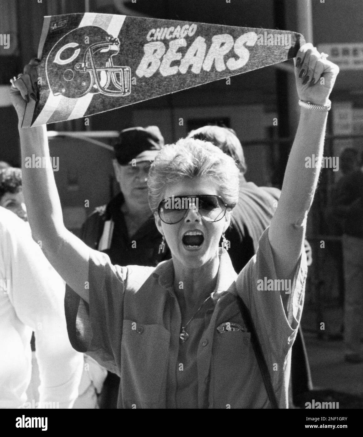 Diana Ditka, wife of Chicago Bears’ head coach Mike Ditka, holds a team ...