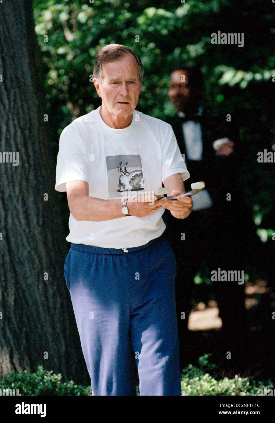 President George Bush wears a shirt bearing the words "Really, I'm fine ...