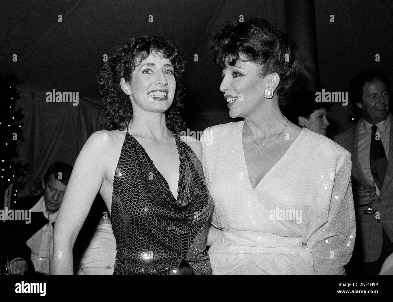 Actress Joan Collins, right, star of “Dynasty,” gives a welcome hug to ...
