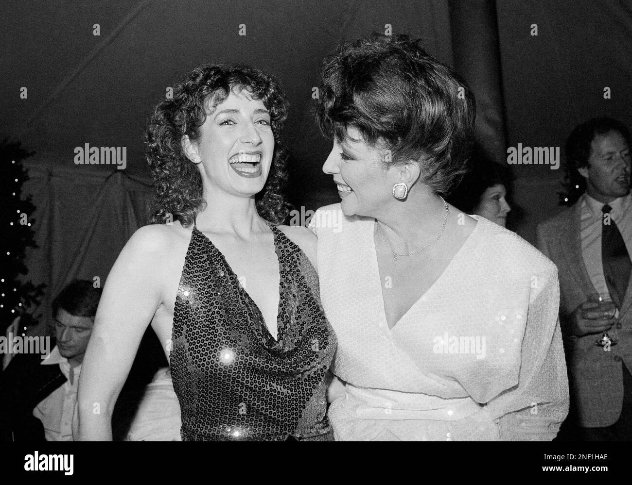 Actress Joan Collins, right, star of “Dynasty,” gives a welcome hug to ...