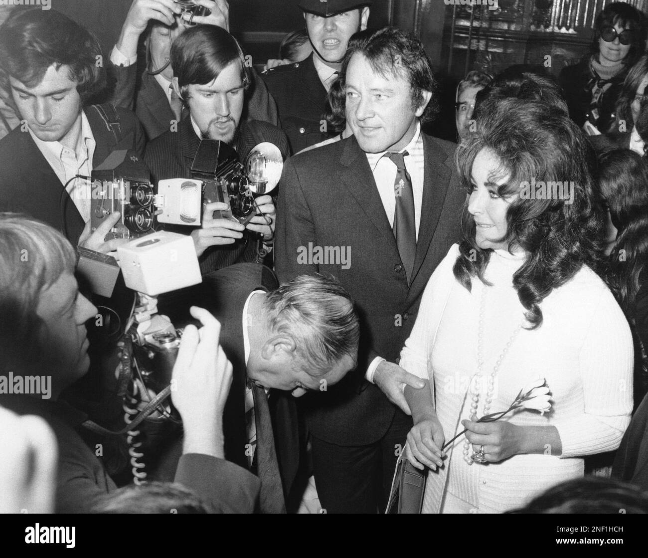 Actress Elizabeth Taylor and her husband Richard Burton are confronted ...