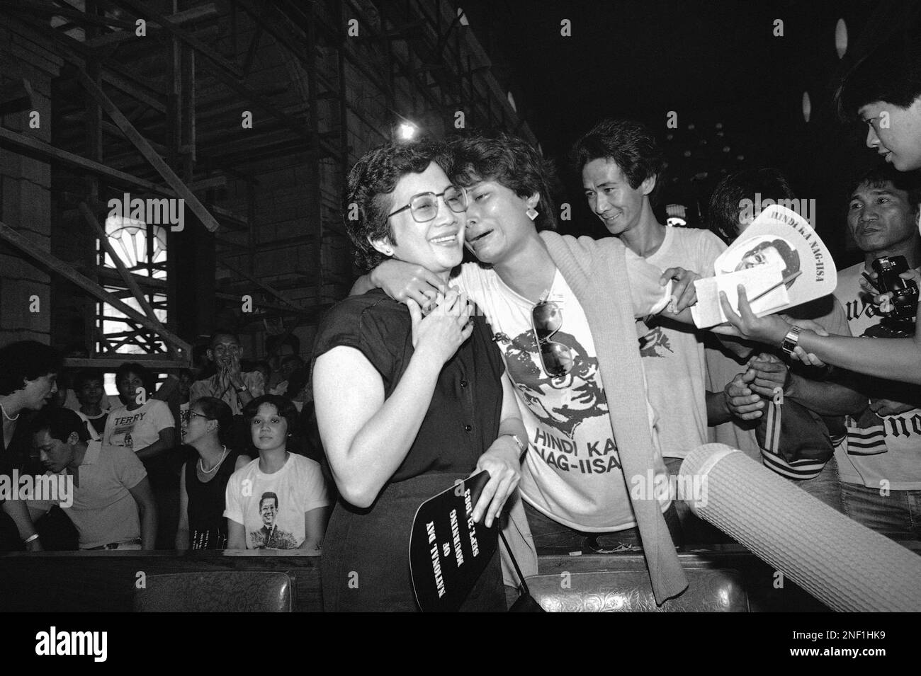 An unidentified woman is overcome by her emotions as she embraces ...