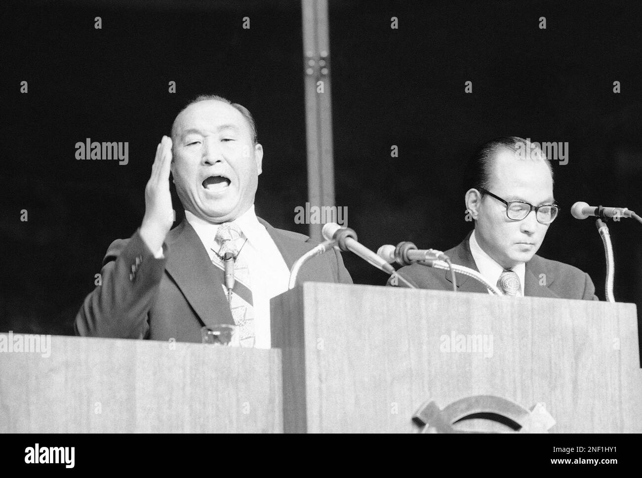 The Rev. Sun Myung Moon standing in front of a protective screen ...