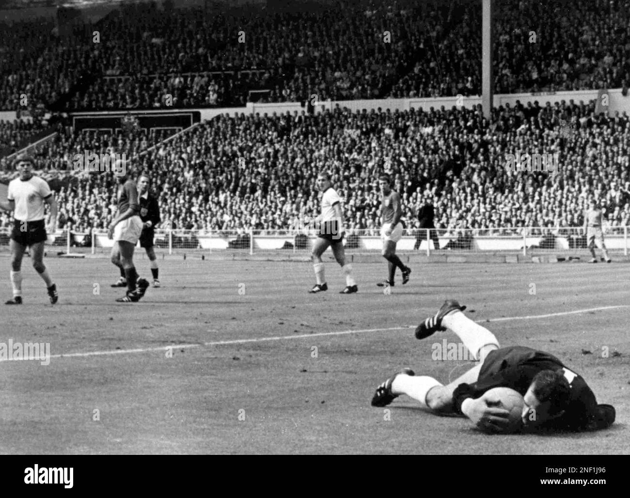 West German goalkeeper Hans Tilkowski, right, saves a shot from England ...
