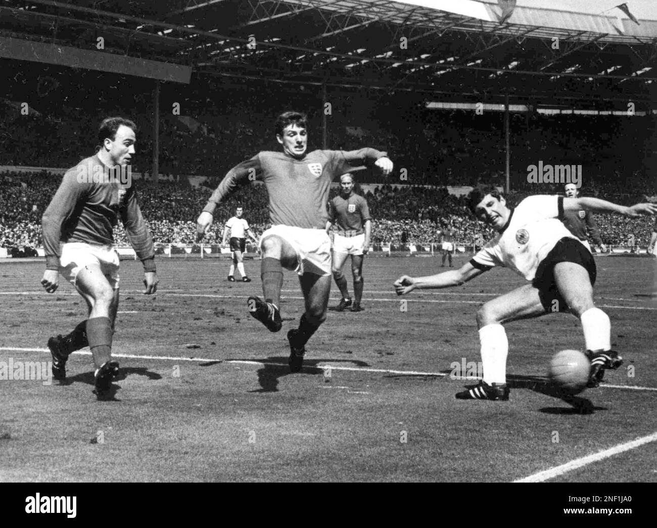 West German forward Lothar Emmerich, right, tries to dribble past ...