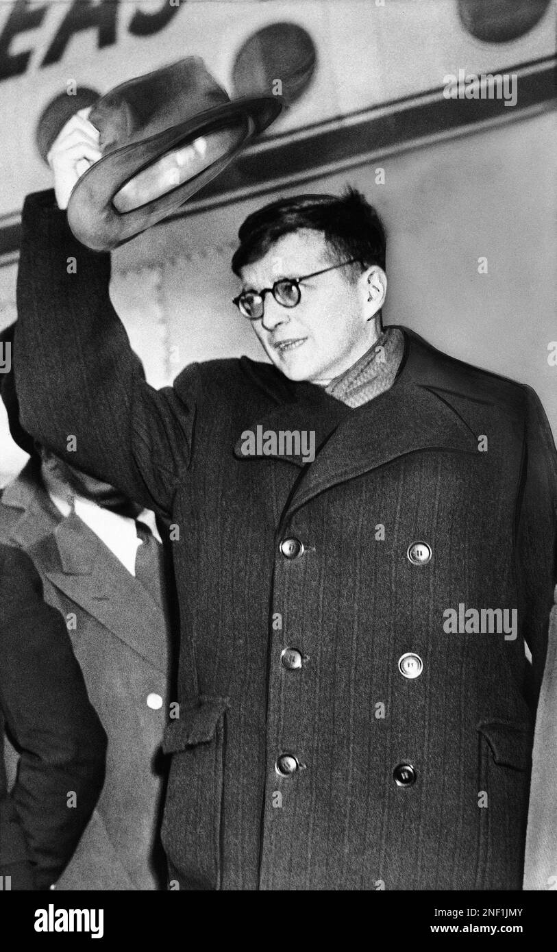 Dmitri Shostakovich, Russian composer, lifts his hat in greeting on ...