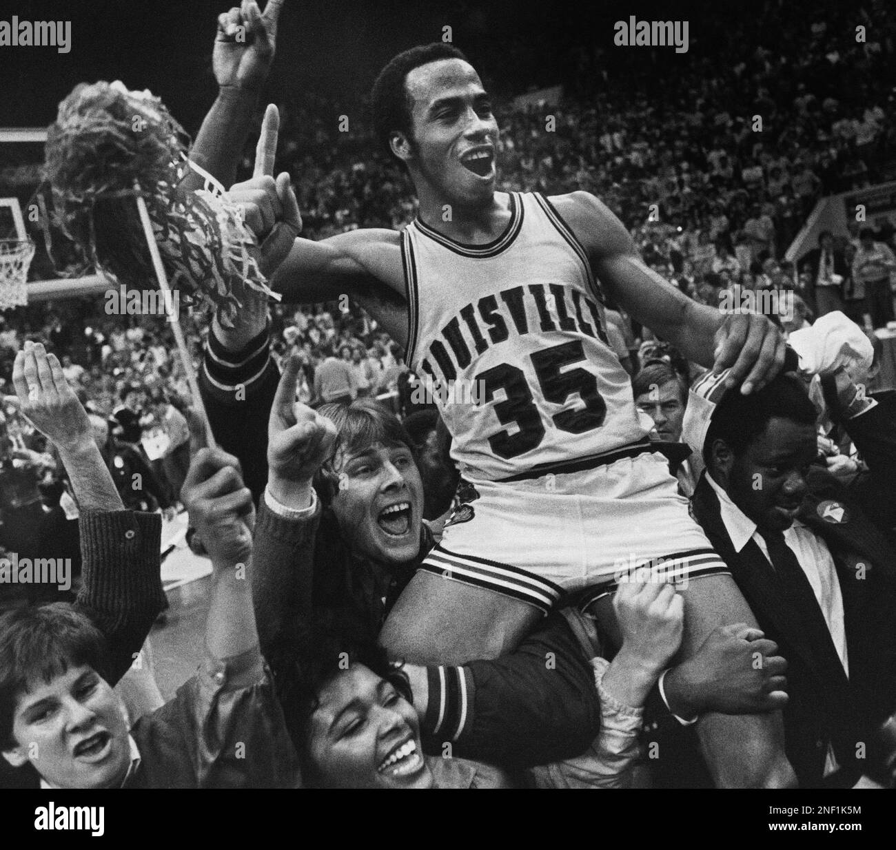 Louisville’s Darrell Griffith flashes number one sign as he’s hoisted ...
