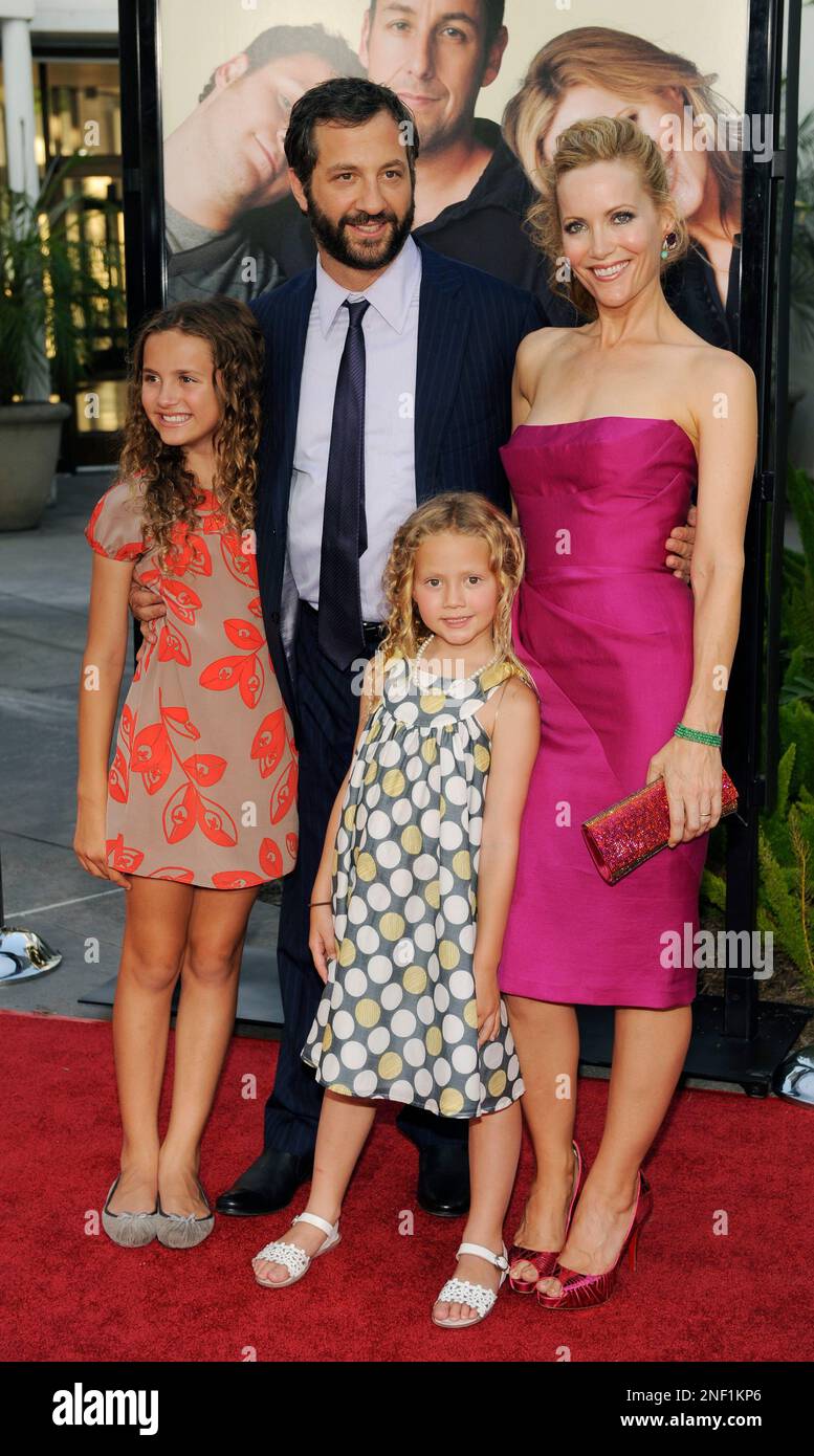 Judd Apatow, center, writer/director/producer of "Funny People," poses with his wife, cast ...