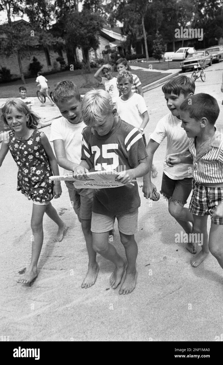 Andrew Aldrin, 10, is followed by a group of neighborhood youngsters ...