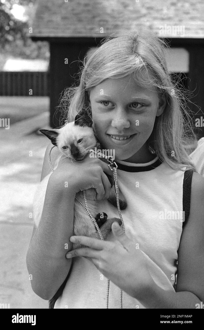 Janice Aldrin, 11, holds her pet kitten “Leif” as she walks across the ...