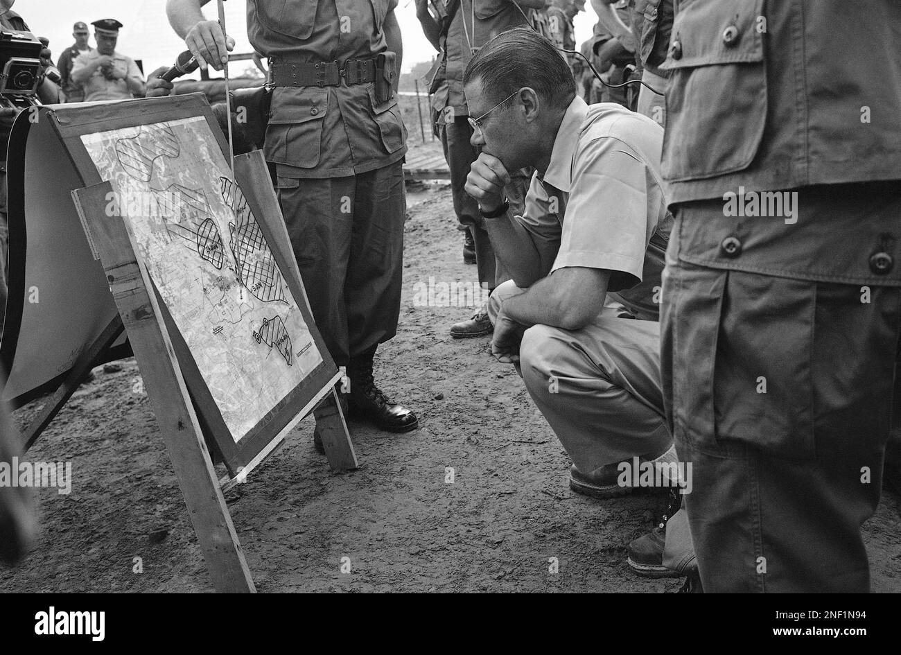 Robert McNamara, U.S. Defense Secretary, inspects a map of Viet Cong ...
