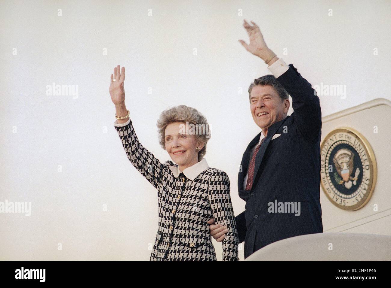 President Ronald Reagan and Mrs. Reagan wave from Air Force One at ...