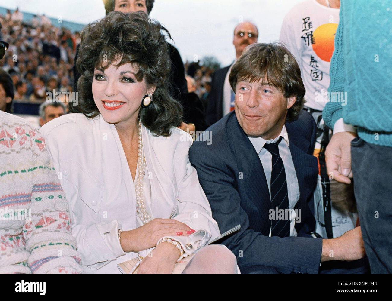 Actress Joan Collins with Bill Wiggins at Hagler-Leonard fight on April ...