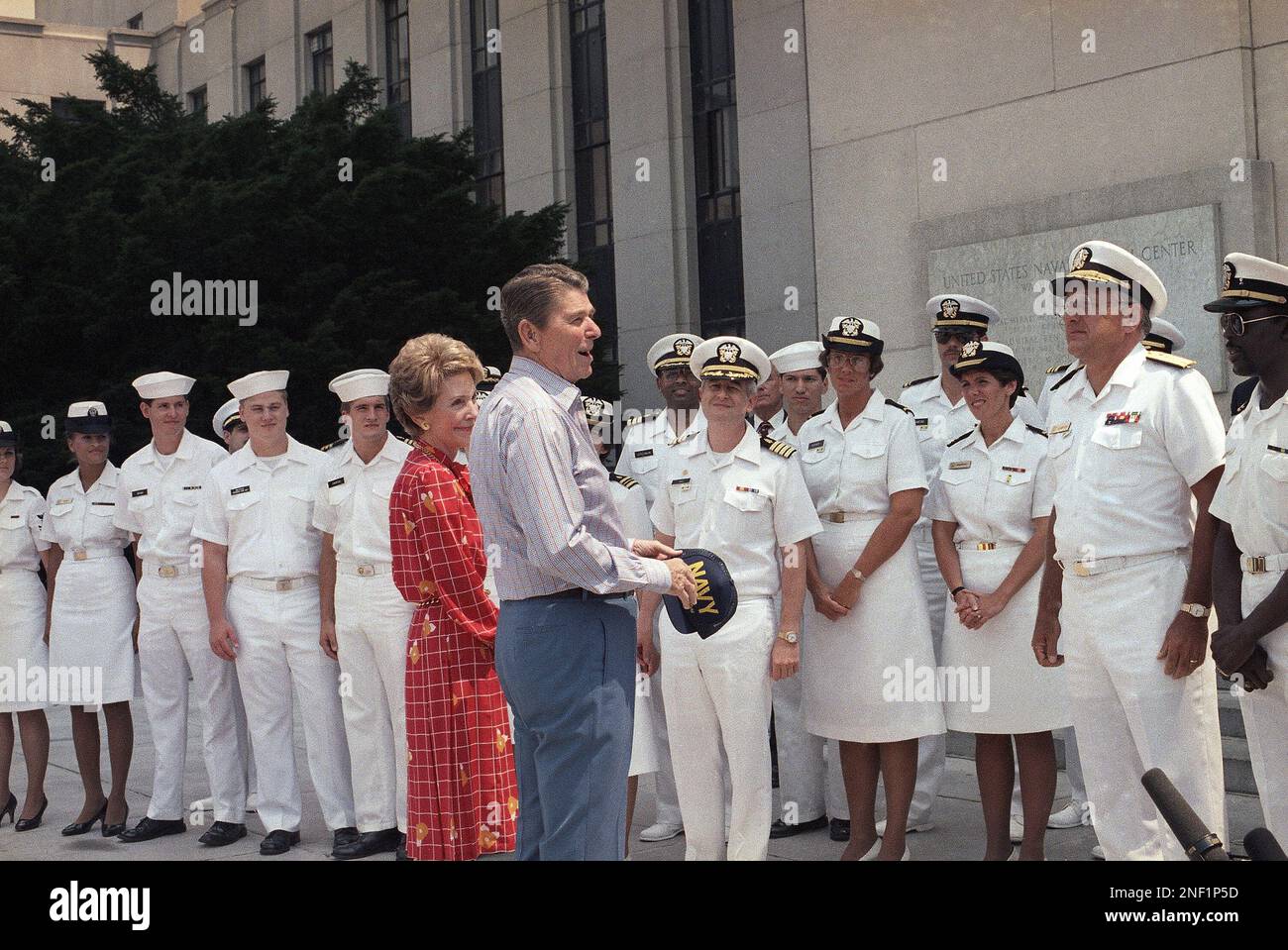 President Ronald Reagan, holding a Navy cap, thanks the medical team of ...
