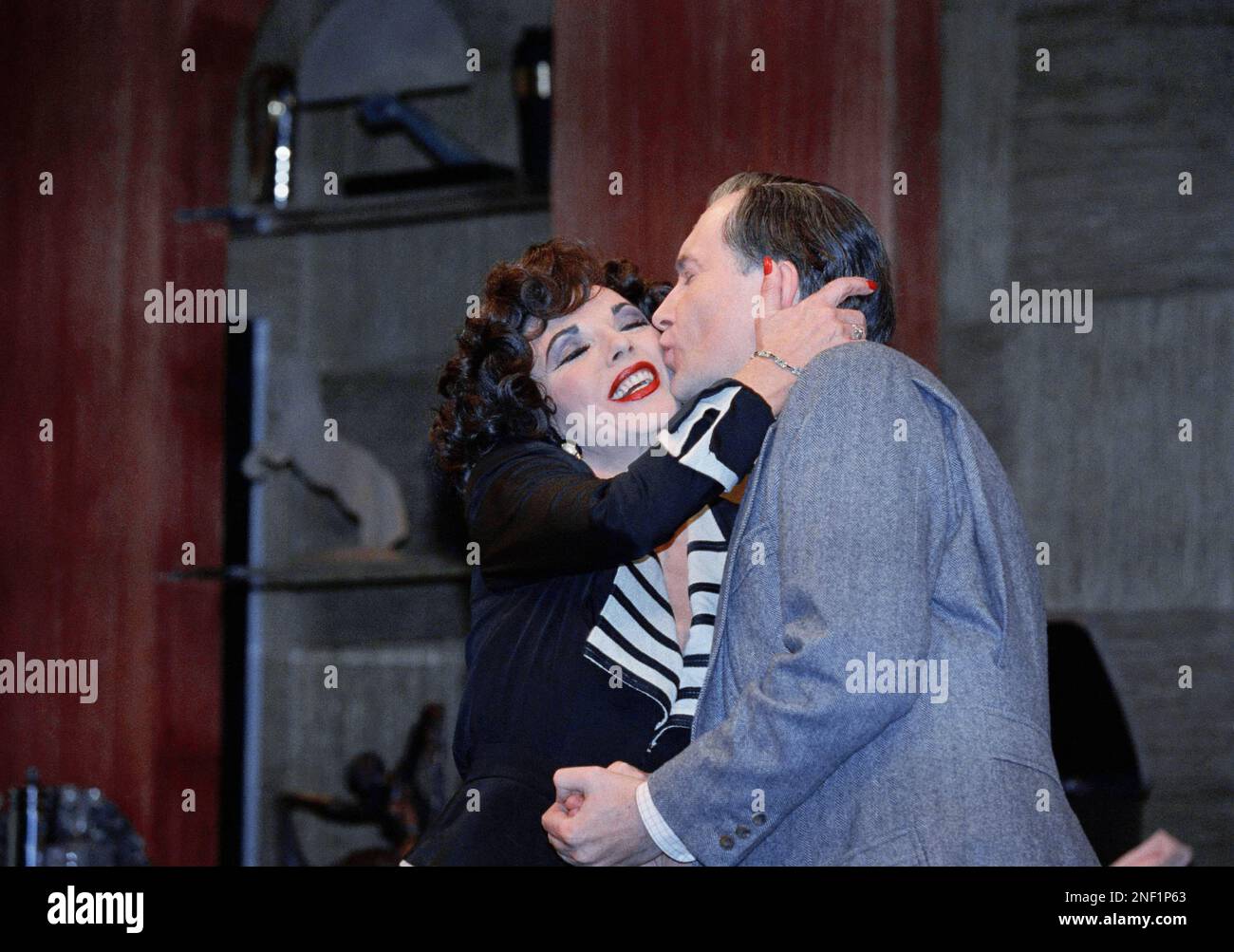 Joan Collins gets a kiss from her co-star Simon Jones during curtain ...
