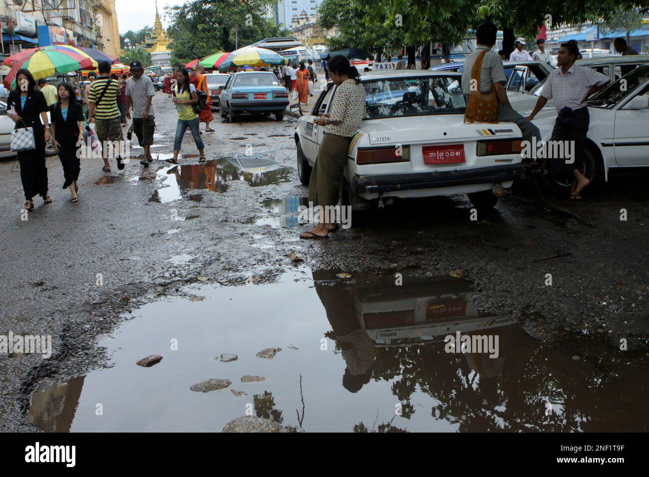 In this photo taken Tuedsay, July 14, 2009, Myanmar taxi drivers wait ...