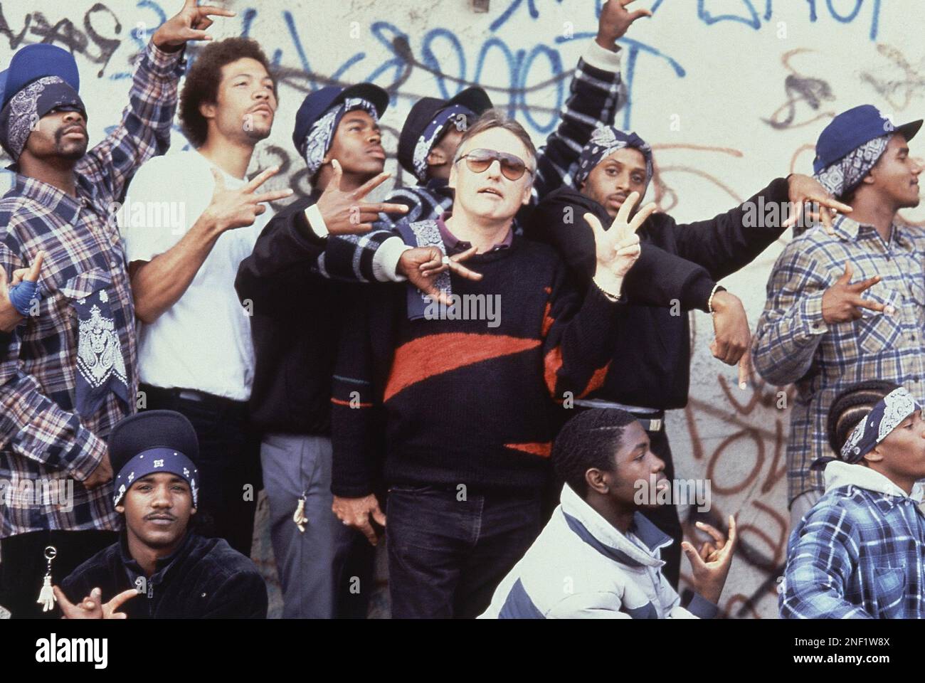 Director Dennis Hopper is surrounded by gang members (rear and extras ...
