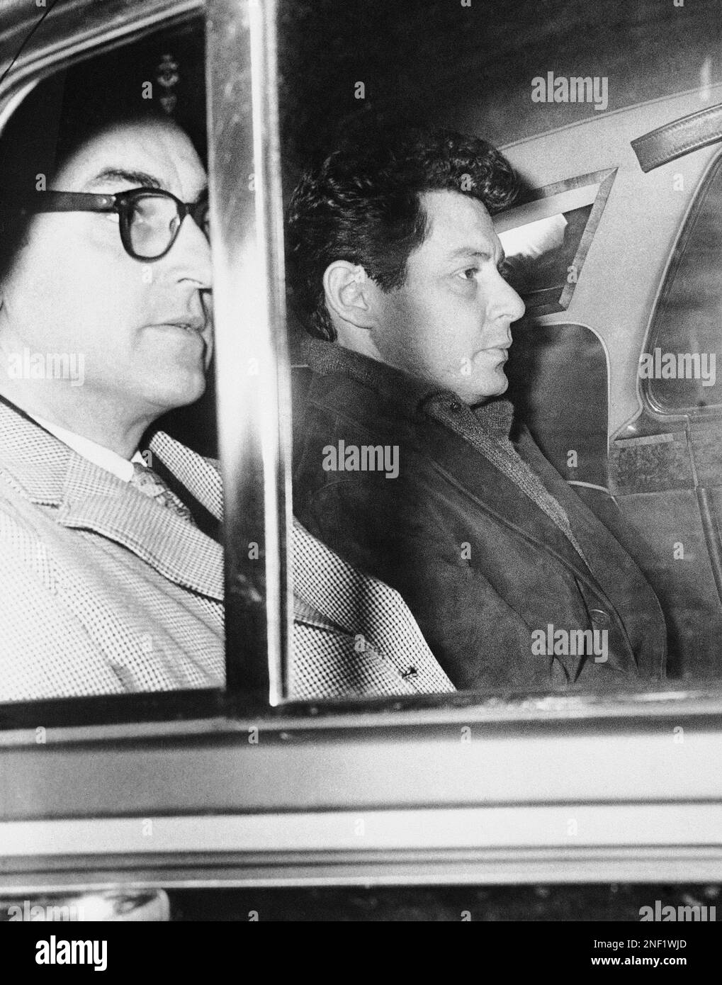 Singer Eddie Fisher, right, sits in car as he leaves London Clinic ...