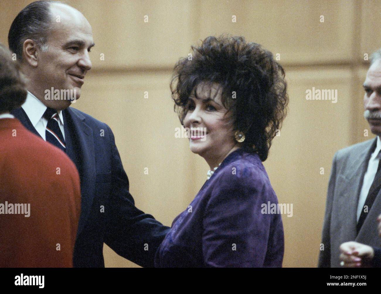 Actress Elizabeth Taylor confers with her attorney, Neil Papiano, in ...