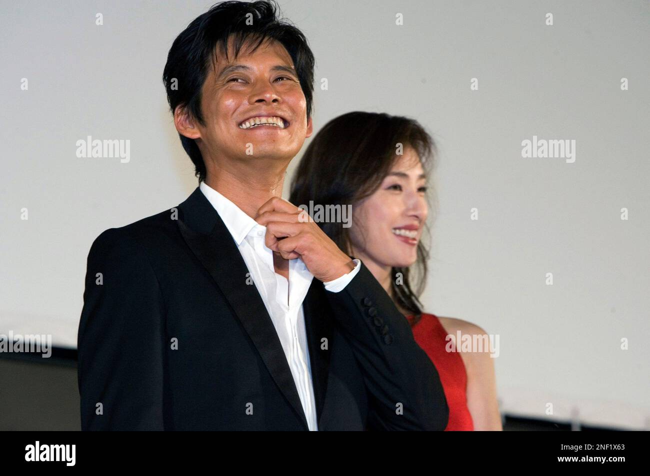 Japanese actor Yuji Oda, left, and actress Yuki Amami reacts during the world premiere of their ...