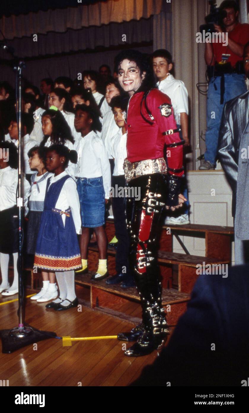 Singer Michael Jackson visits his old school and listens to a childrens ...