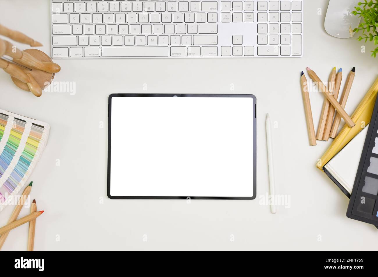 Top view of a minimal white graphic designer or editor workspace with ...