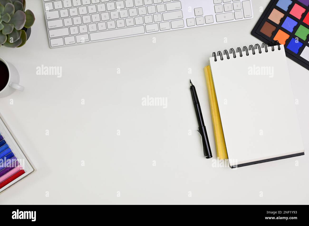 Modern white workspace tabletop background with keyboard, color checker ...