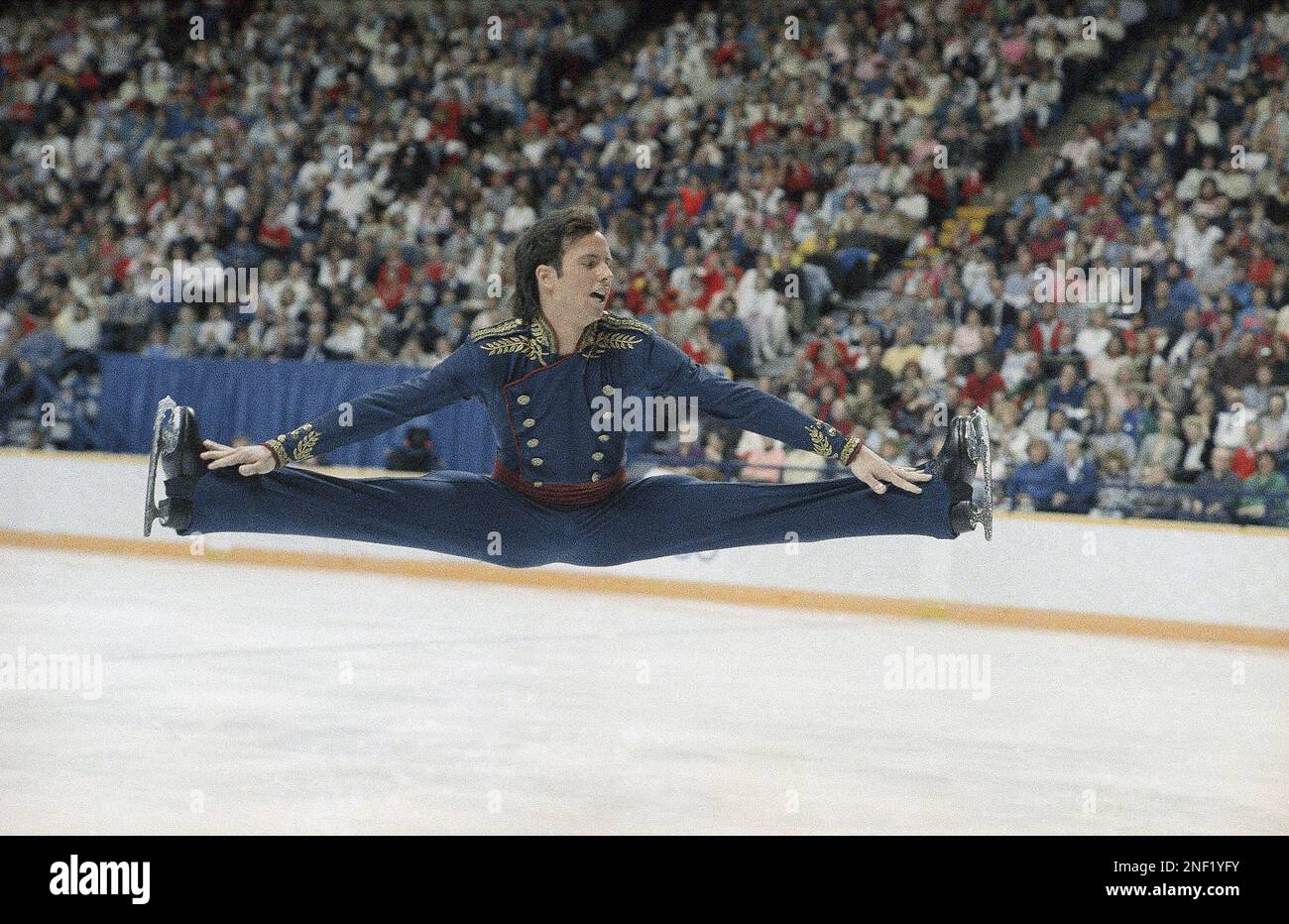 Brian Boitano of Sunnyvale, Calif., leaps in the air, touching his ...