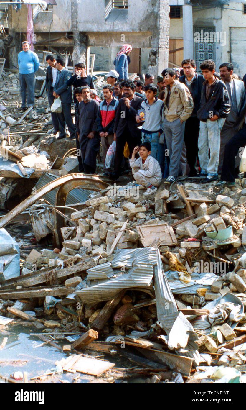 Iraqi's look at the aftermath after allied bombing. The area hit was ...