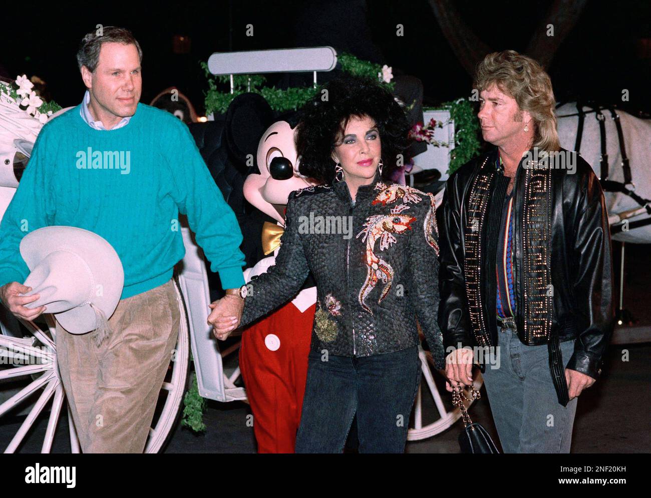Actress Elizabeth Taylor is joined by husband Larry Fortensky, right ...