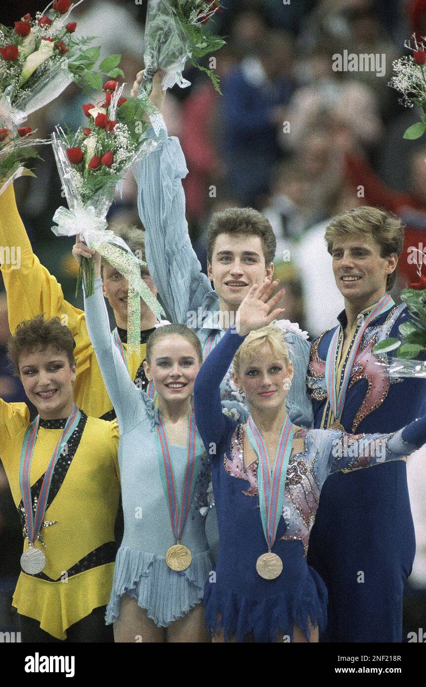 Three medal winner of Tuesday’s pair figure skating wave to a cheering ...