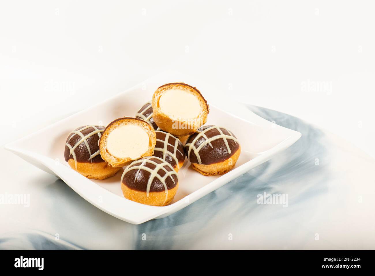 Six pack of gluten free profiteroles covered in milk and white ...