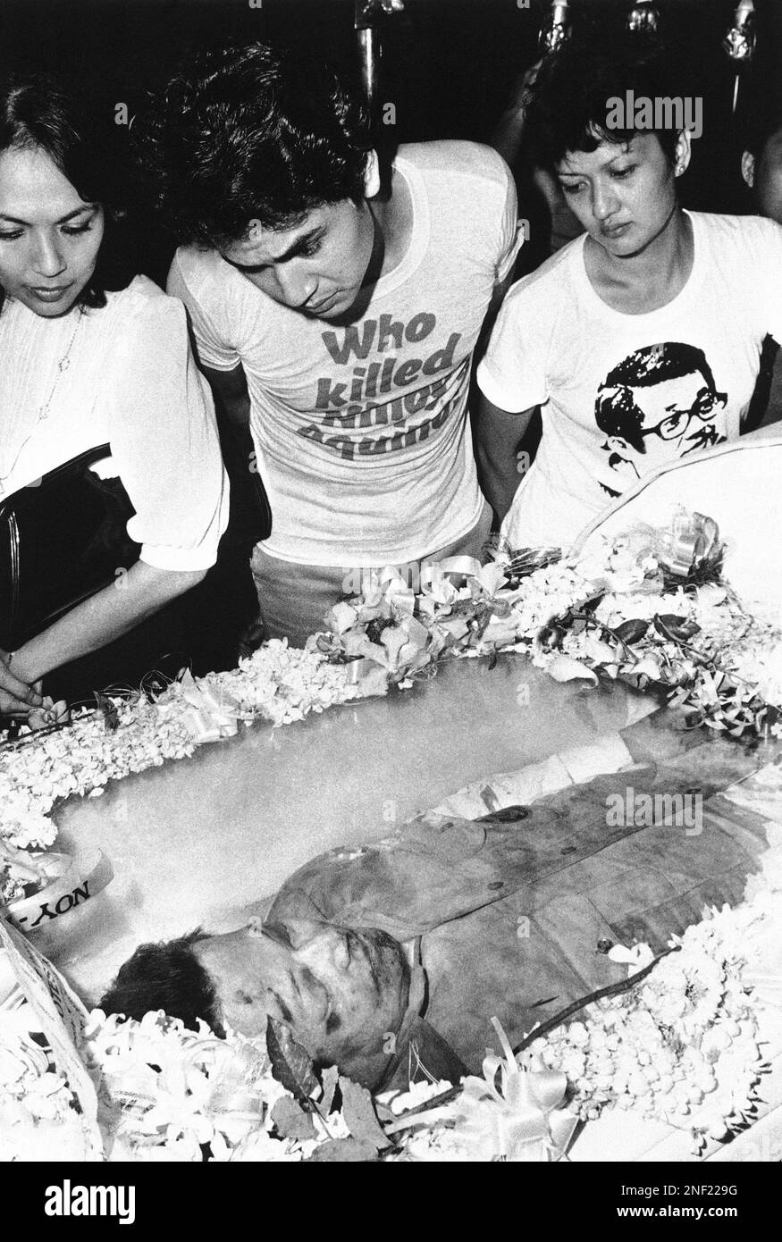 A young man looks at the body of former Senator Benigno Aquino, Aug. 24 ...