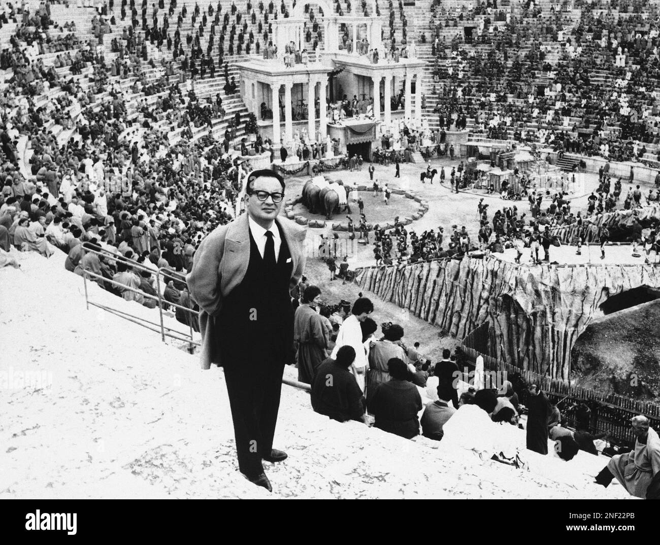Well above the arena, Italian producer Dino De Laurentiis turns his ...