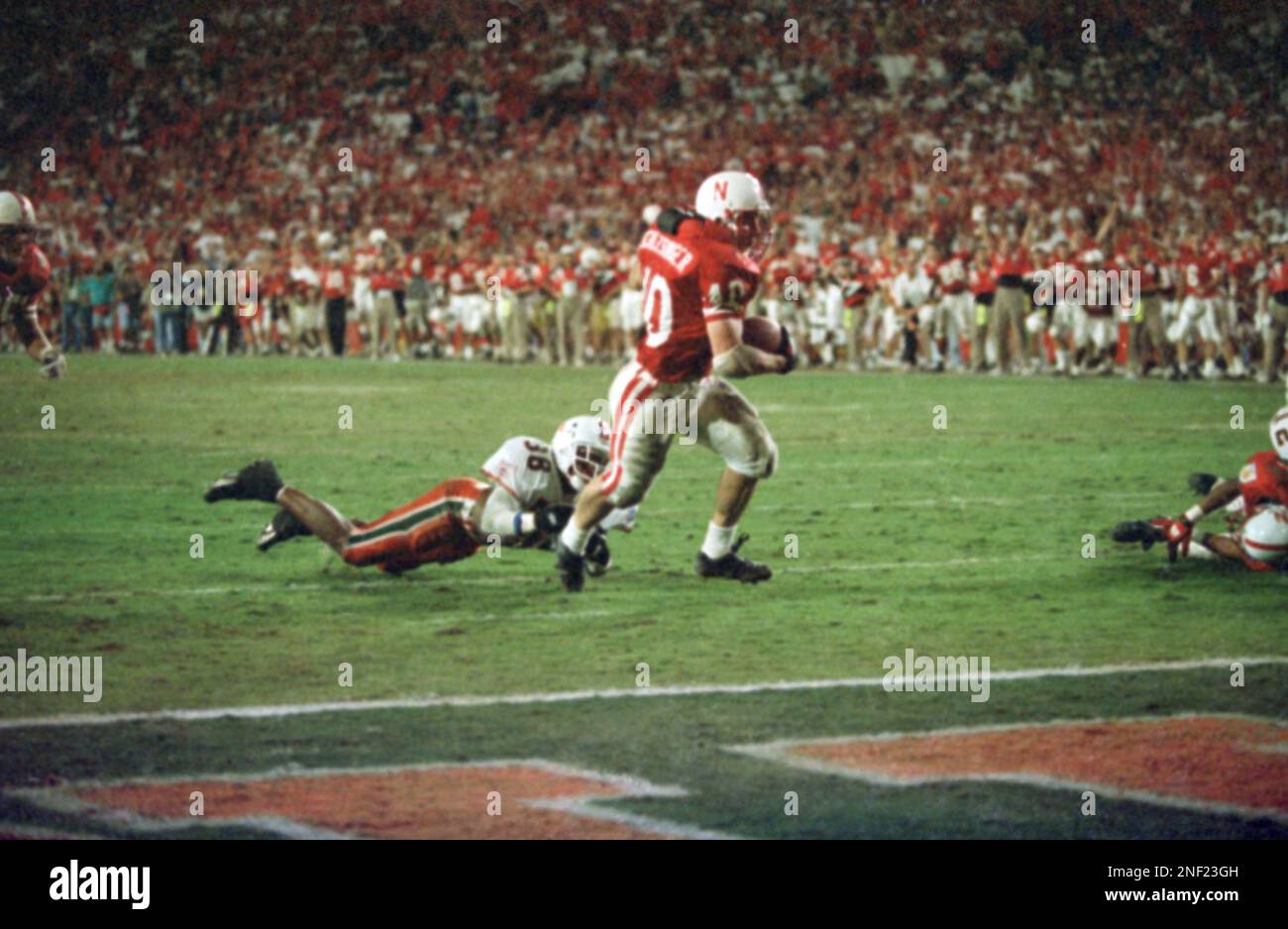Nebraska fullback Cory Schlesinger (40) outruns Miami safety Malcolm ...