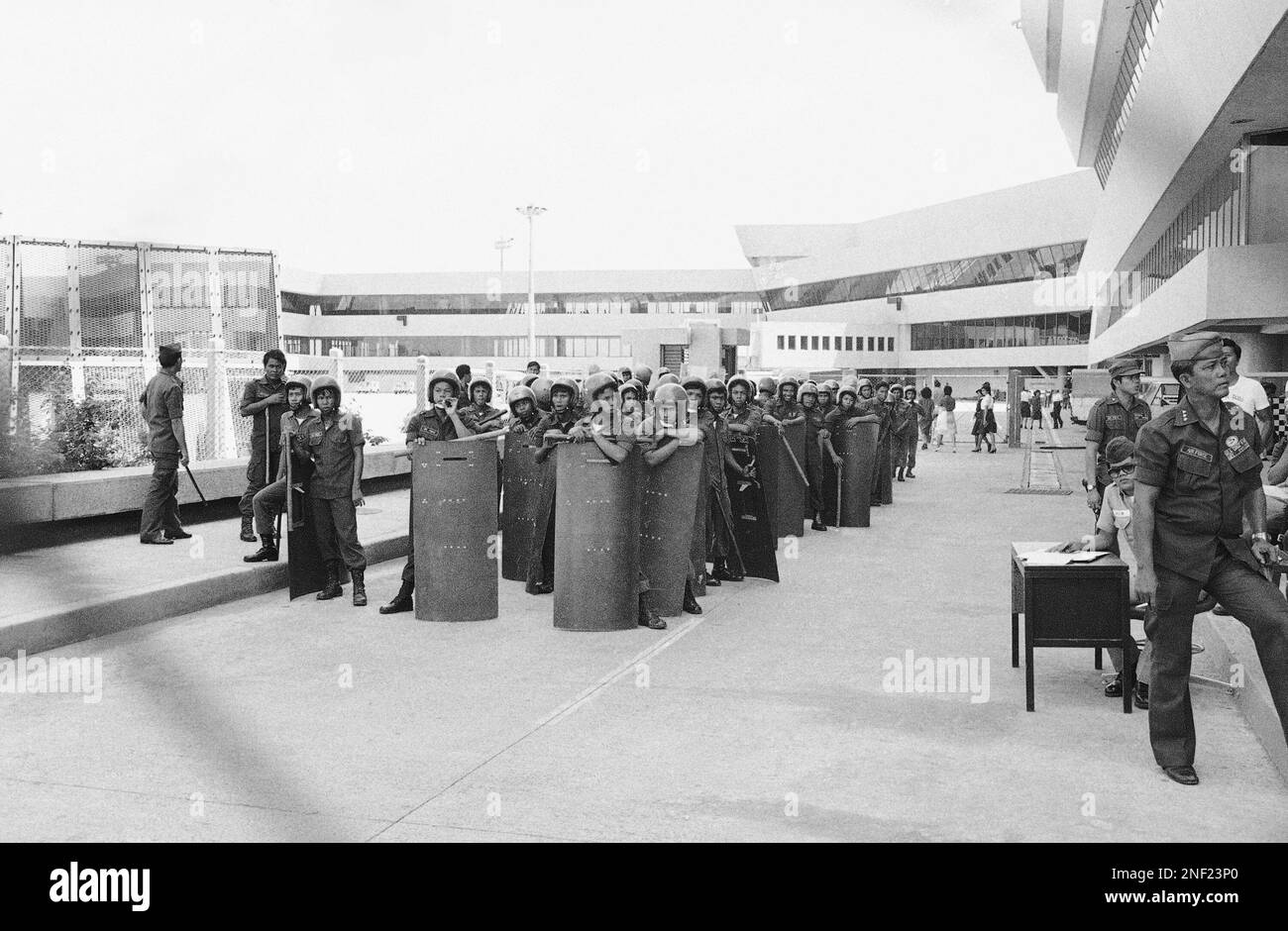 Riot police are seen at the airport where former Senator Benigno Aquino ...