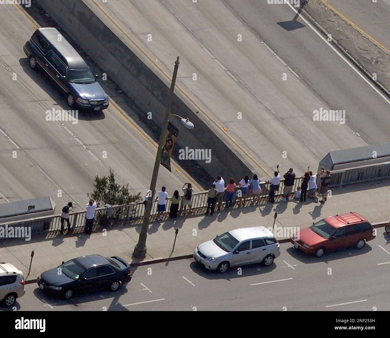 Well-wishers wave as a hearse makes its way to the Staples Center for a ...