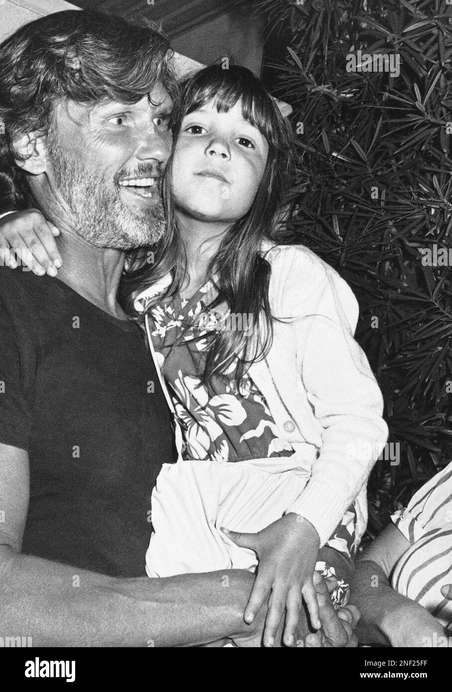 Singer-actor Kris Kristofferson holds his daughter Casey after opening ...