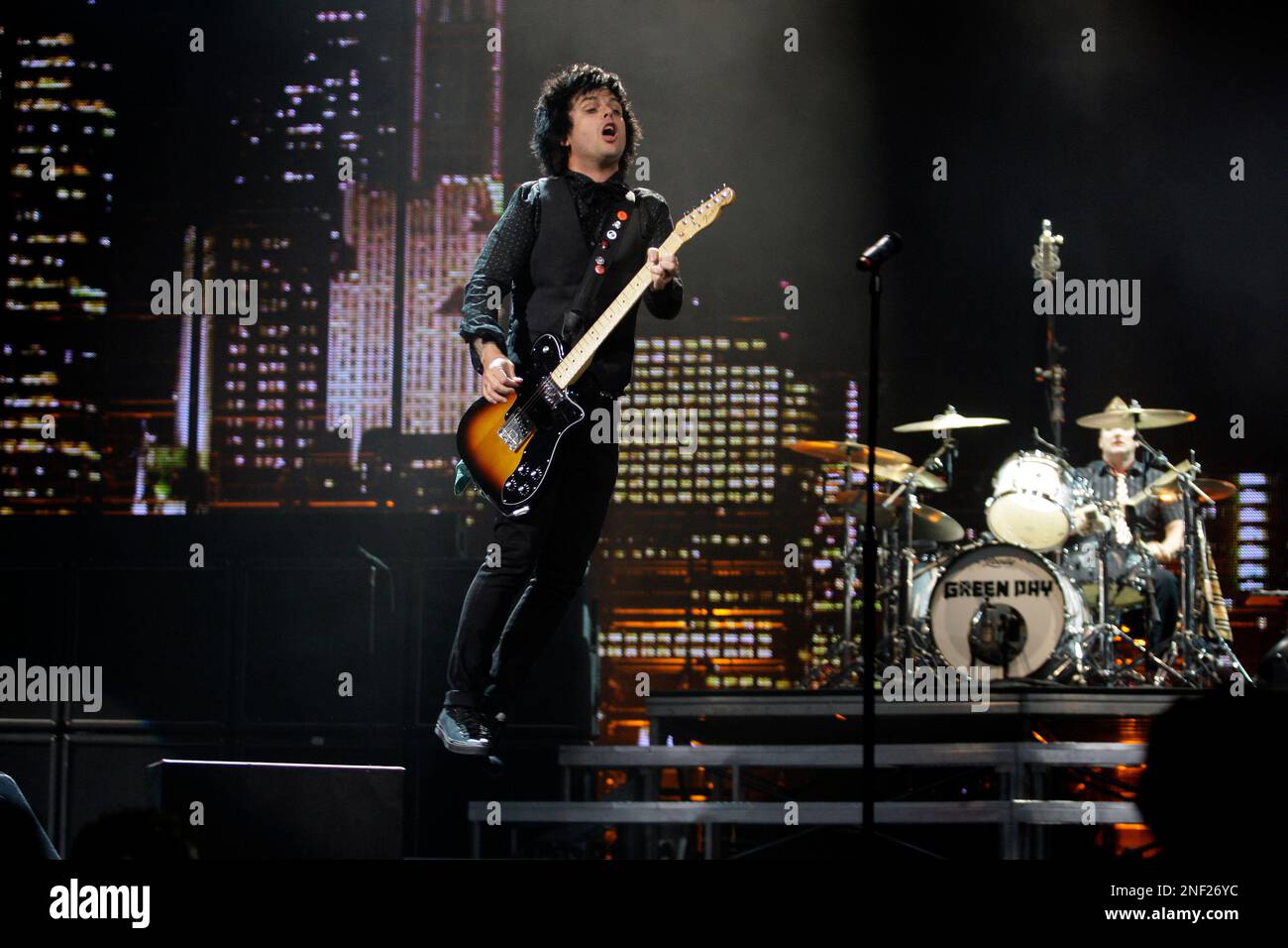 Green Day lead singer Billie Joe Armstrong jumps off a speaker as he ...