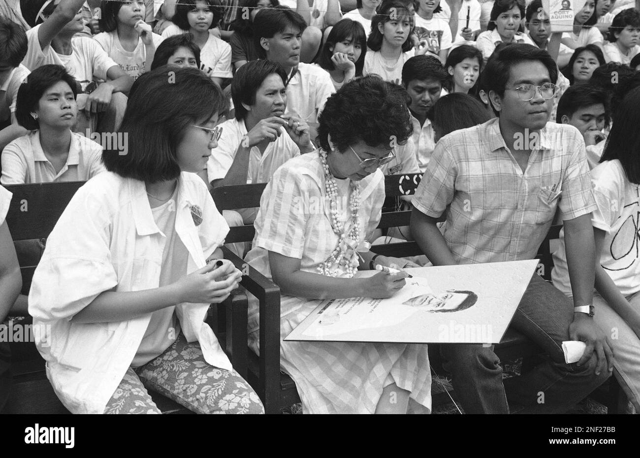 Opposition presidential candidate Corazon “Cory” Aquino autographs a ...