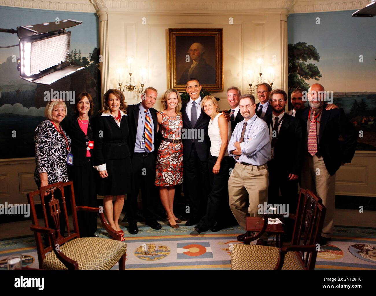 President Barack Obama, center, poses with members of The Associated ...